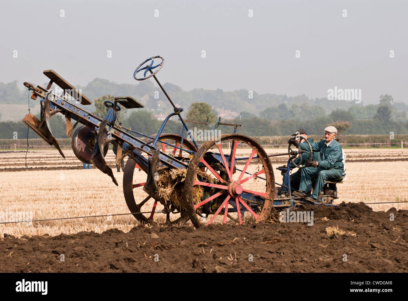A balance plough being pulled by a cable from a Fowler Ploughing Engine ...
