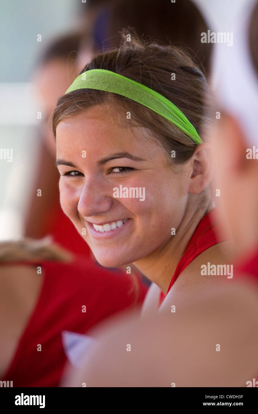 Female Softball Player Smiles From Inside Dugout Stock Photo - Alamy