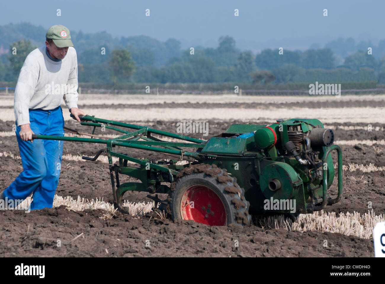 Man using a petrol driven rotavator at a ploughing match Stock Photo ...