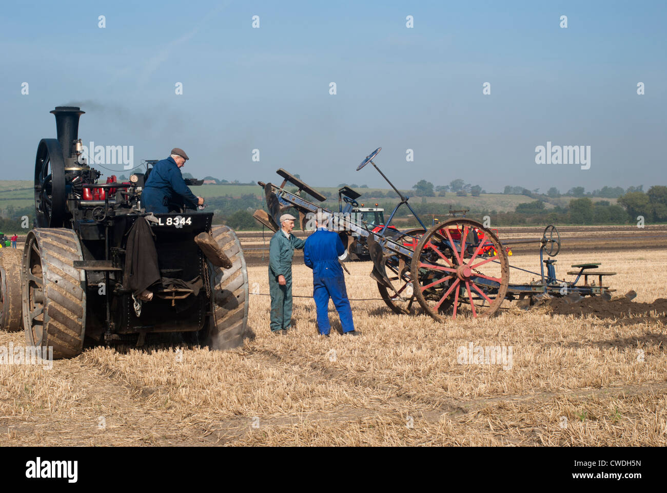 The plough being pulled by a cable from a Fowler Ploughing Engine Stock ...
