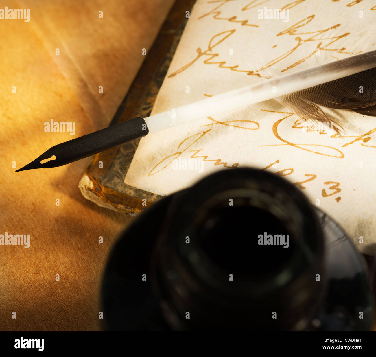 Old book with feather and inkpot Stock Photo - Alamy