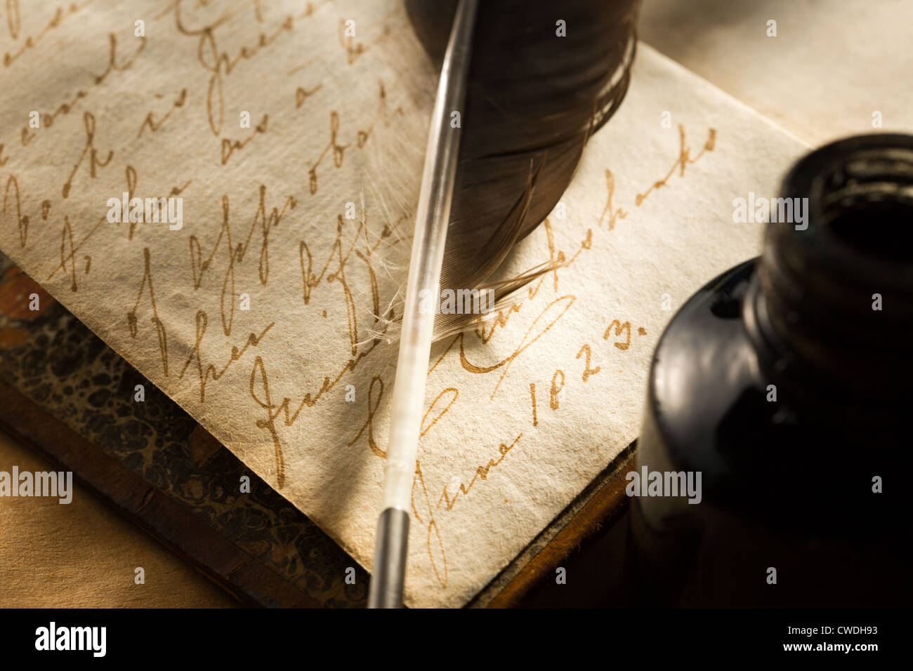 Old book with feather and inkpot Stock Photo - Alamy