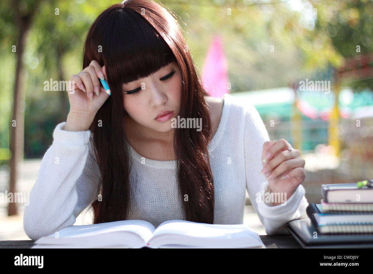 A smiling Asian student is studying Stock Photo - Alamy