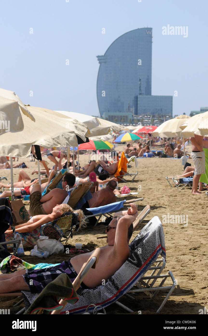 man smoking a cigar on the beach under his umbrella Stock Photo - Alamy