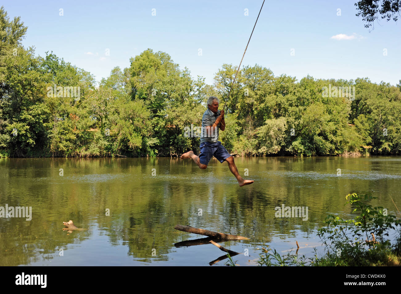 Man swinging over the river hi-res stock photography and images - Alamy