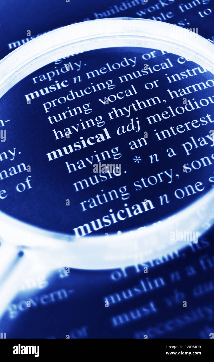 Music concept with dictionary and magnifying glass Stock Photo - Alamy