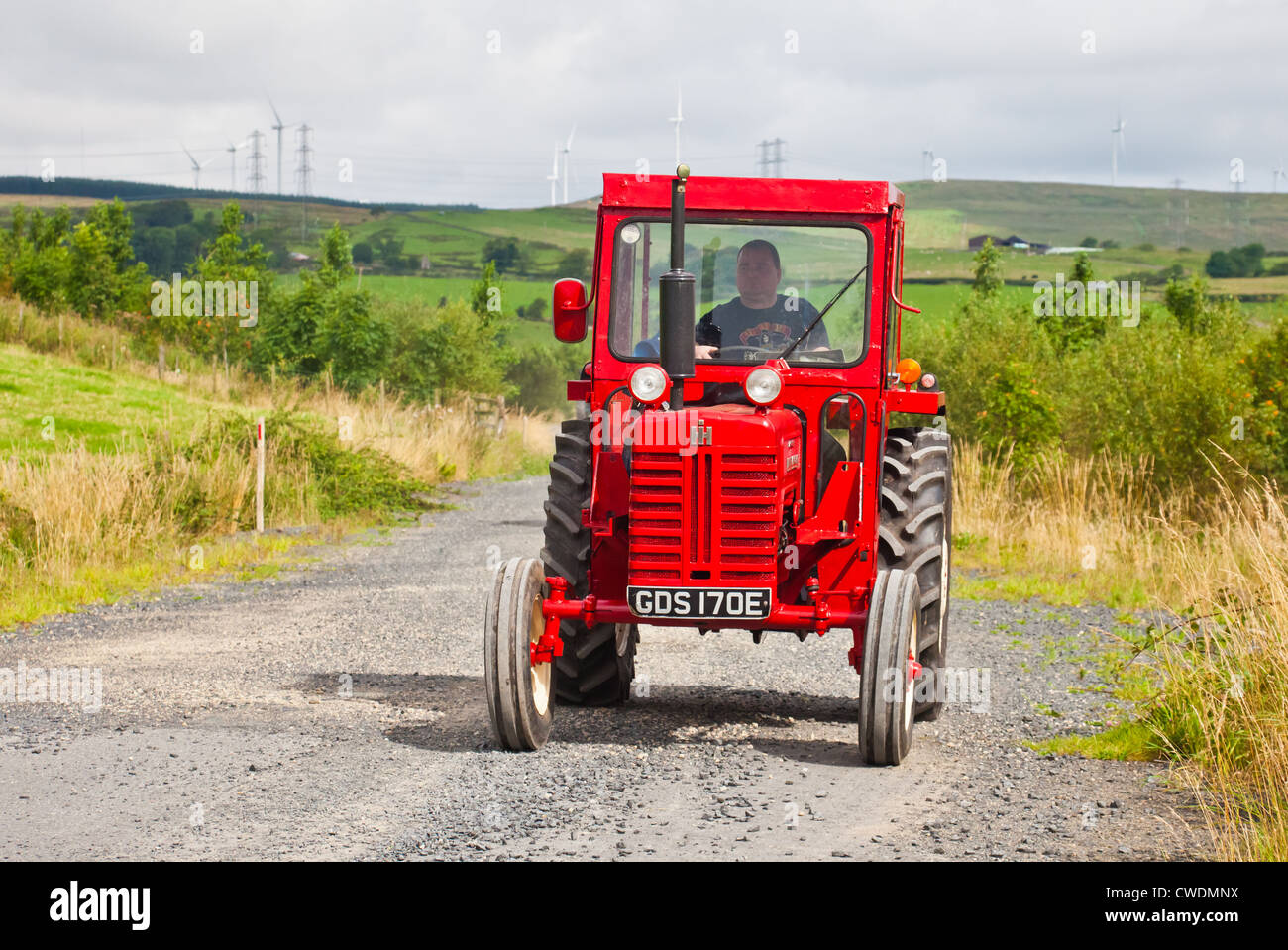 Enthusiast driving a red International Harverster vintage tractor ...