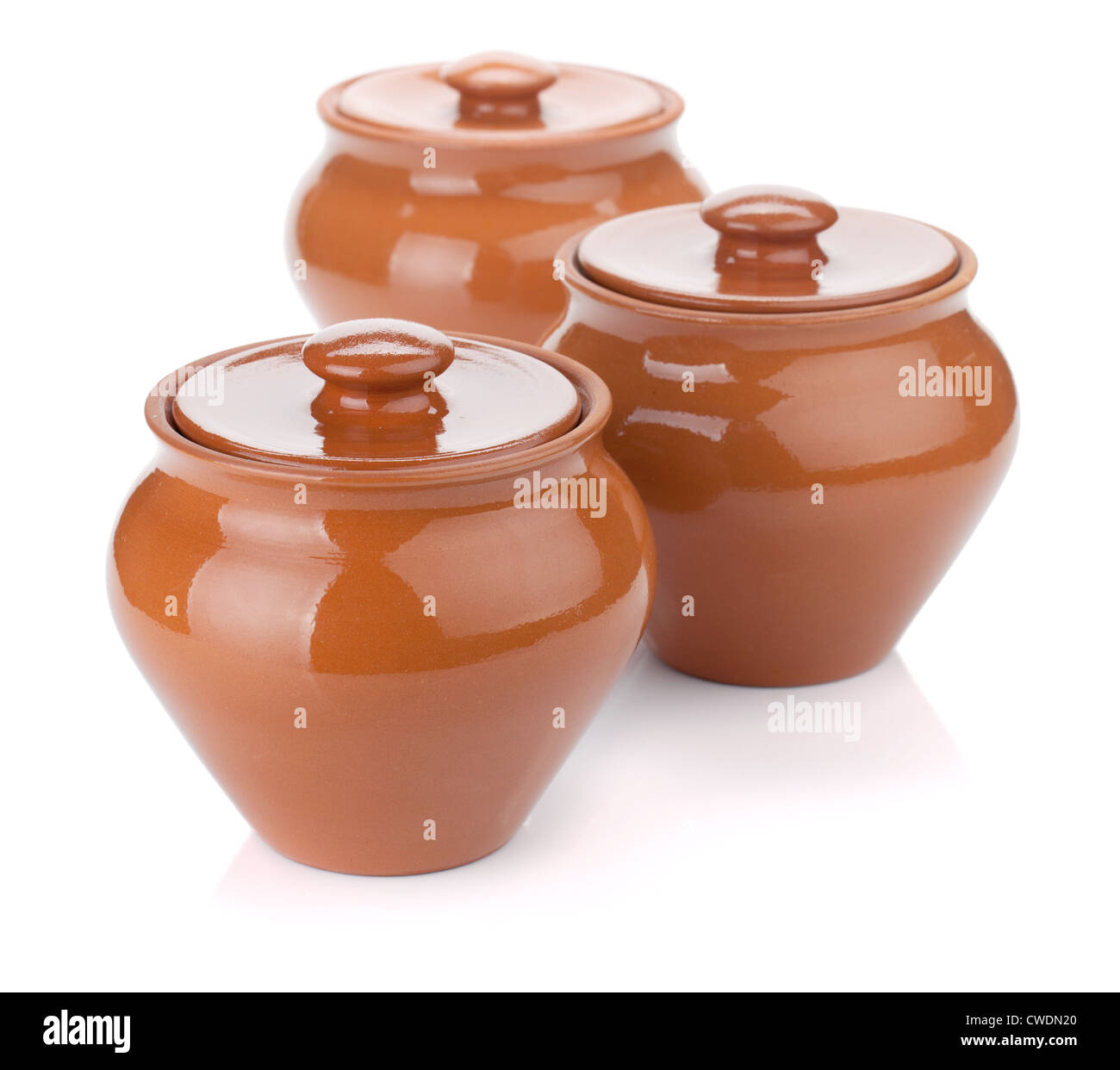 Three clay pots. Isolated on white background Stock Photo - Alamy