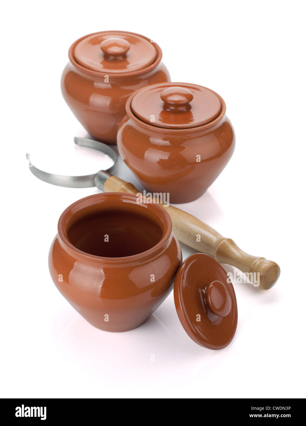 Three clay pots and holder. Isolated on white background Stock Photo ...