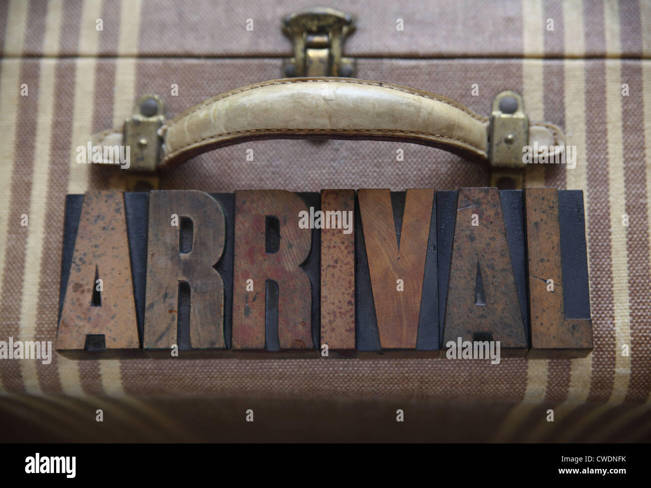 the word arrival in old wood type on a well-used suitcase Stock Photo ...