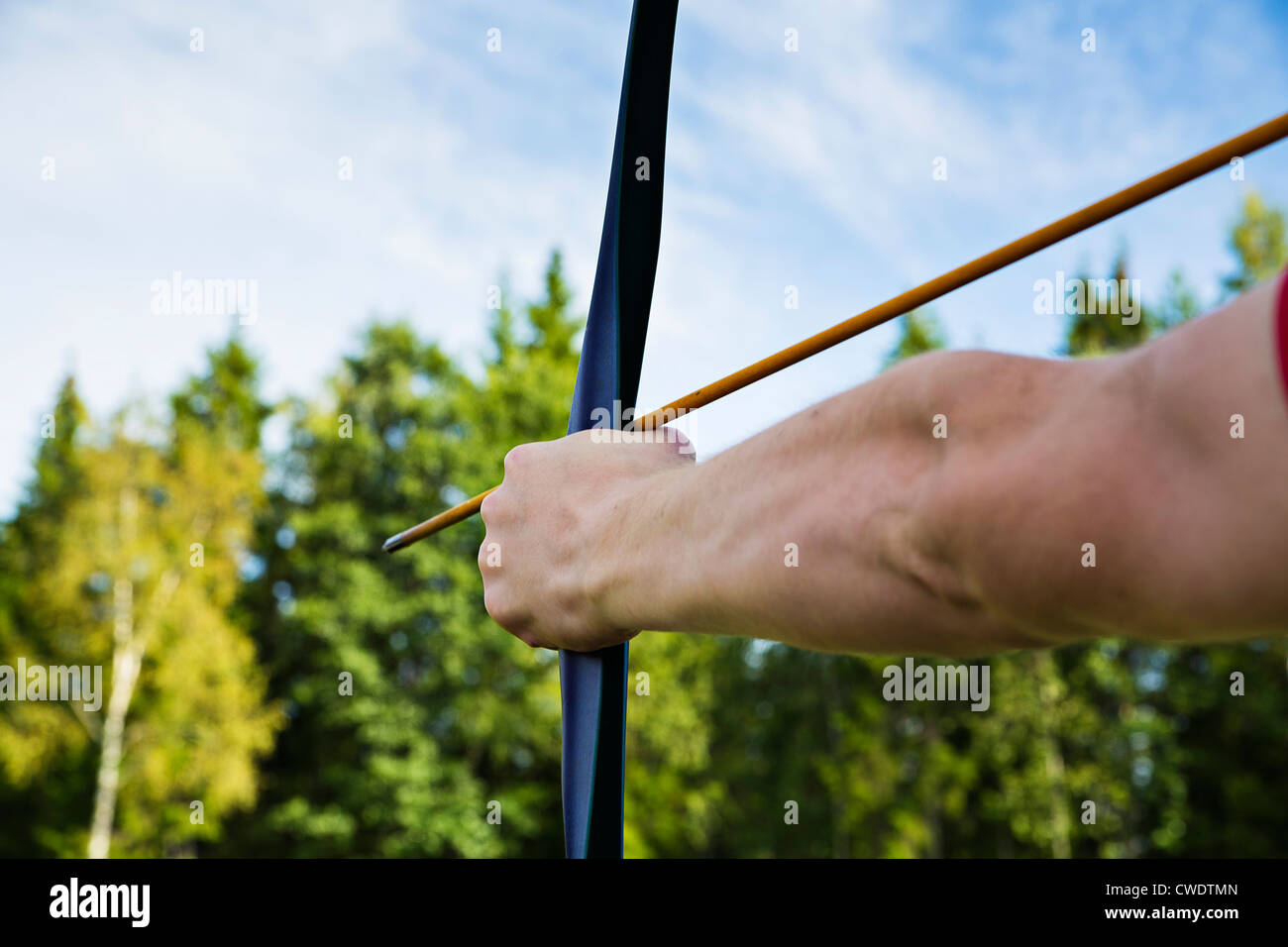 Man is ready to shoot from sport bow Stock Photo - Alamy