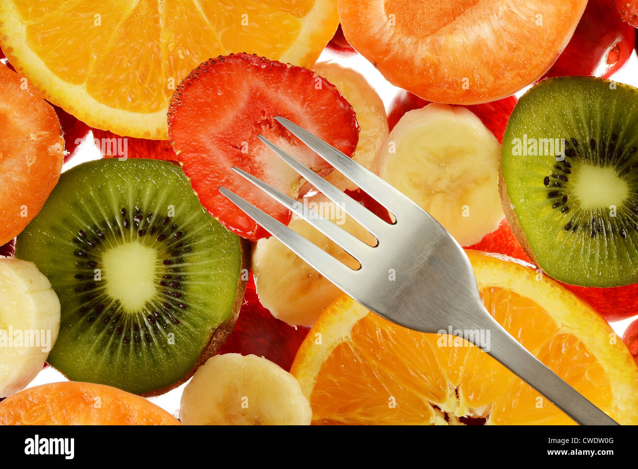 Composition with variety of fruits and fork Stock Photo - Alamy