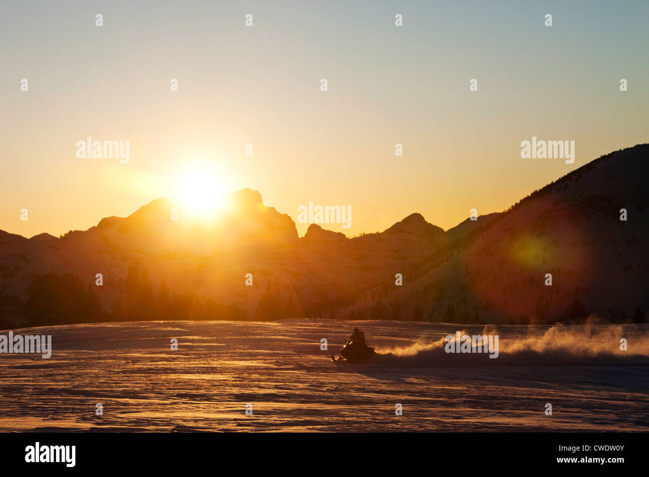 A athletic young man snowmobiling at sunset in Montana Stock Photo - Alamy