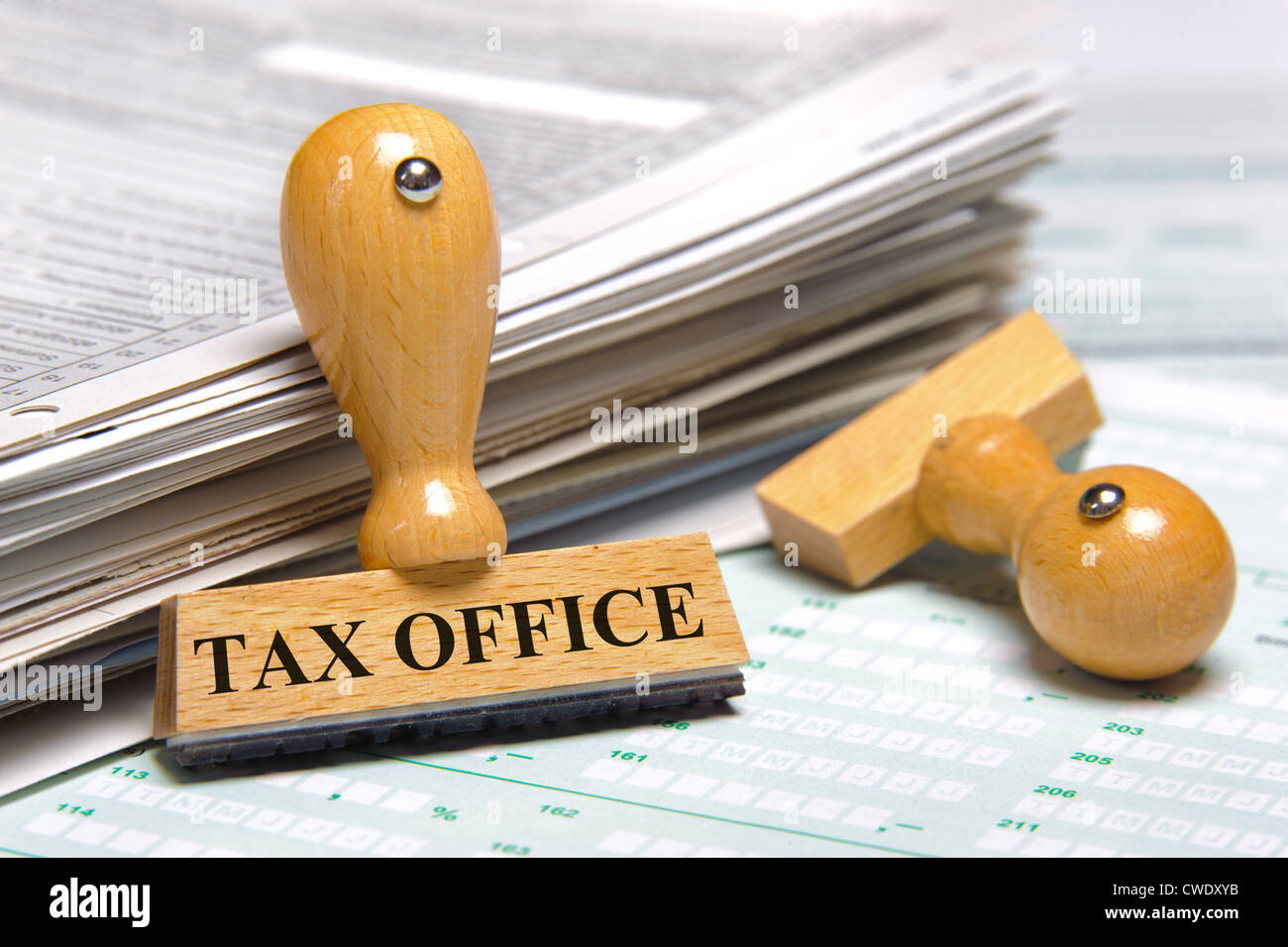 rubber stamp marked with tax office on financial papers Stock Photo - Alamy