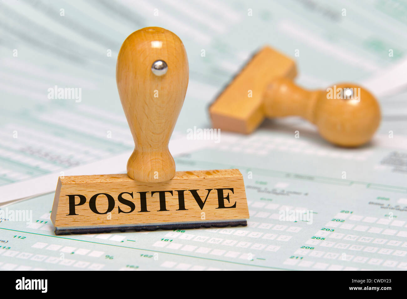 rubber stamp on documents marked with positive Stock Photo - Alamy