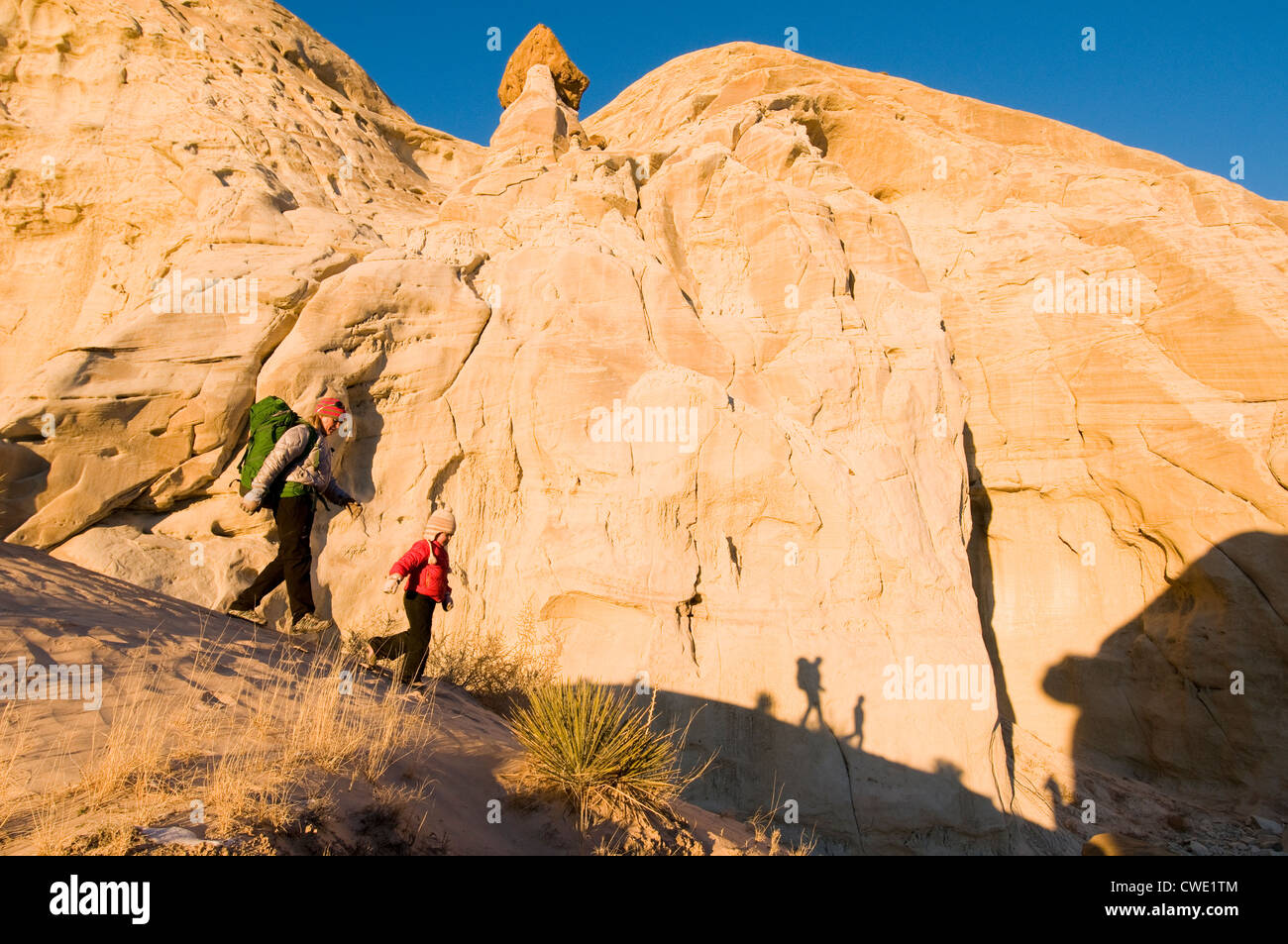 A mother and daughter hiking sandy ridgeline on their way to the ...