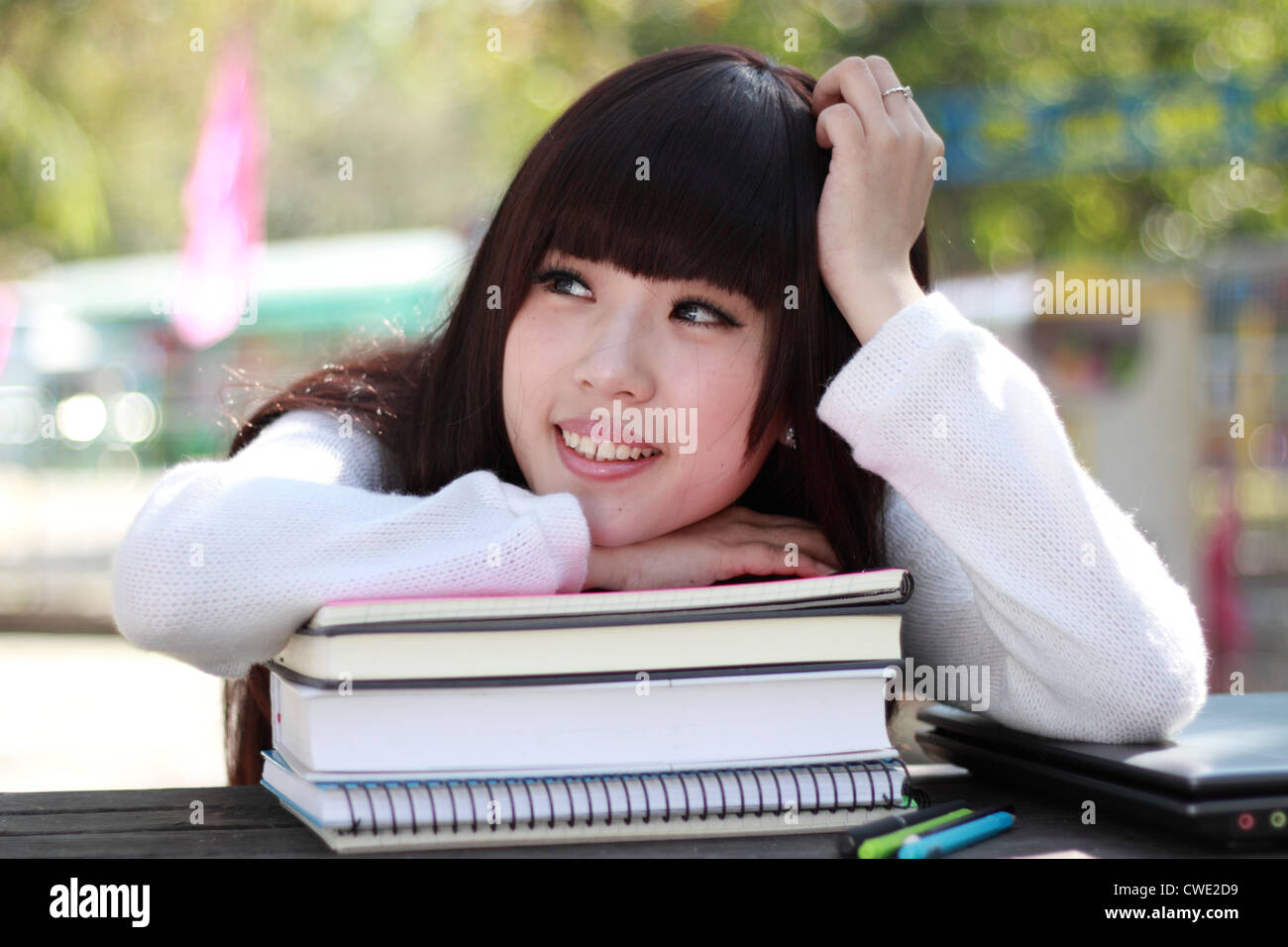A smiling Asian student is studying Stock Photo - Alamy