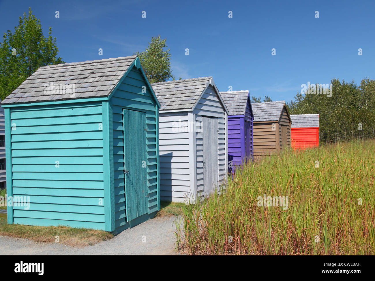 A row of brightly colored small garden sheds Stock Photo - Alamy