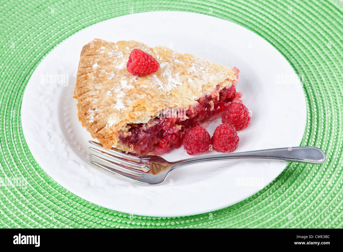 Homemade raspberry pie with fresh ripe raspberries on a white porcelain ...