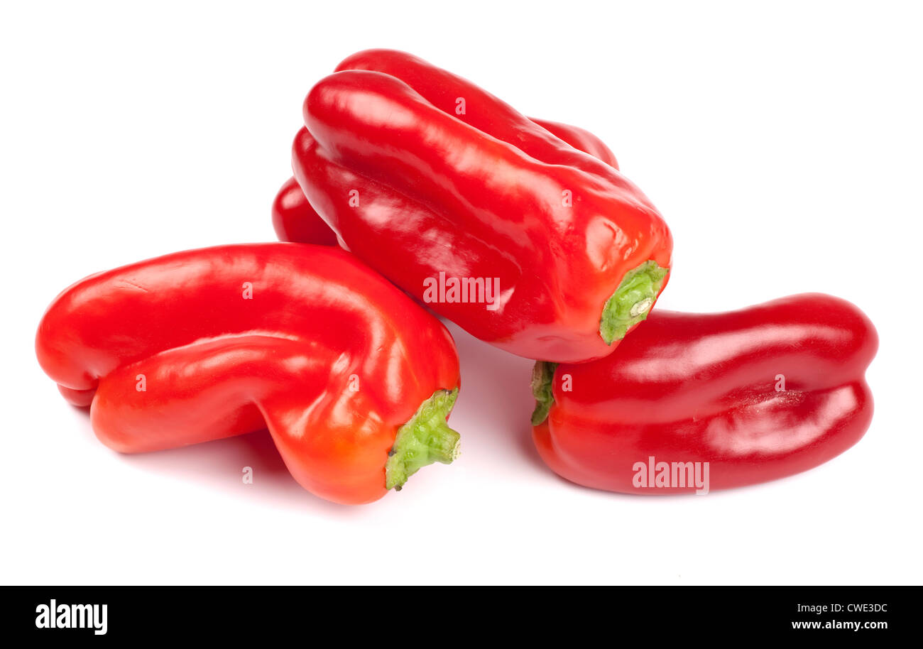Three red peppers on white background Stock Photo - Alamy