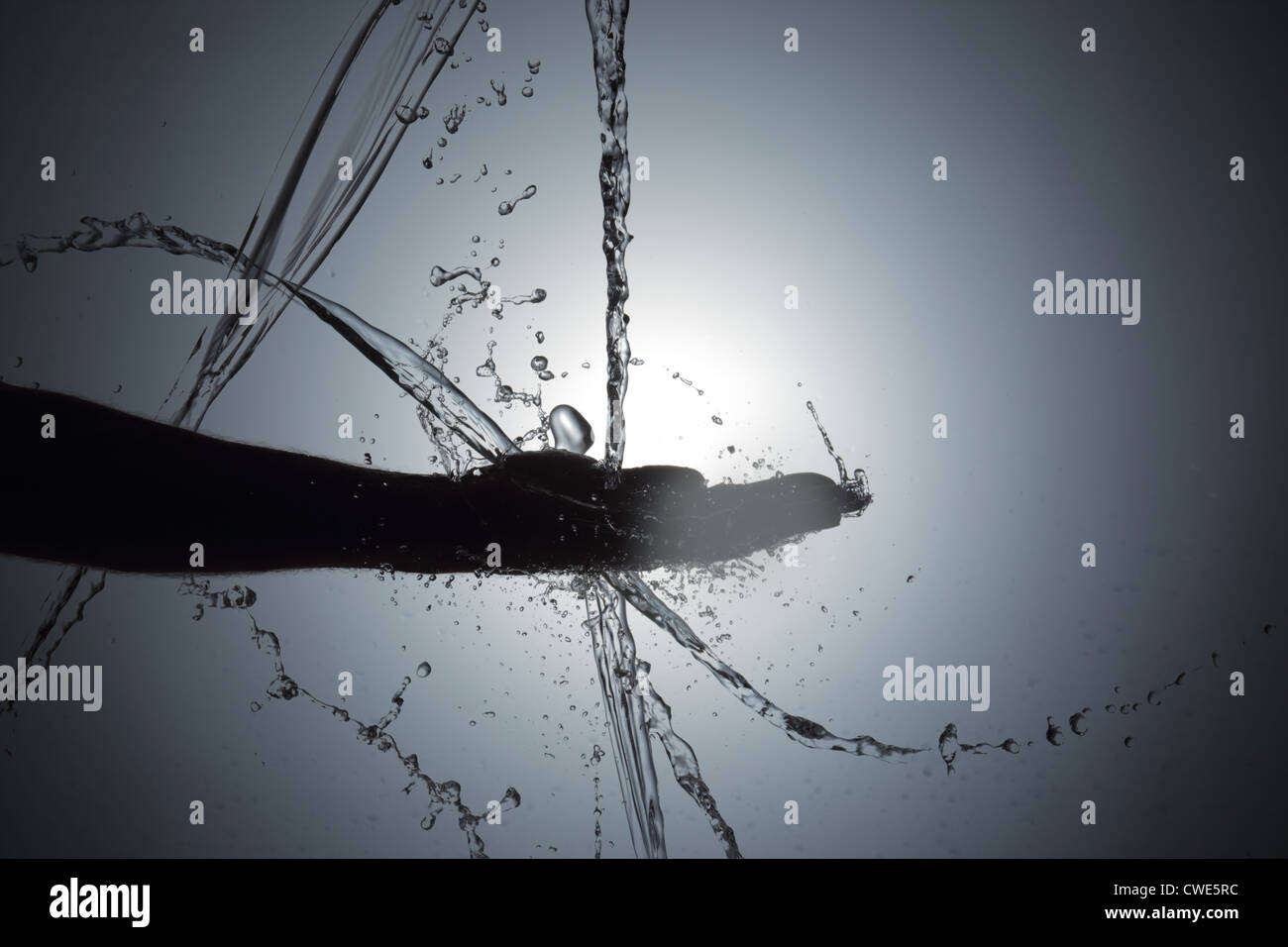 Water Falling On Hand With Backlit Stock Photo - Alamy