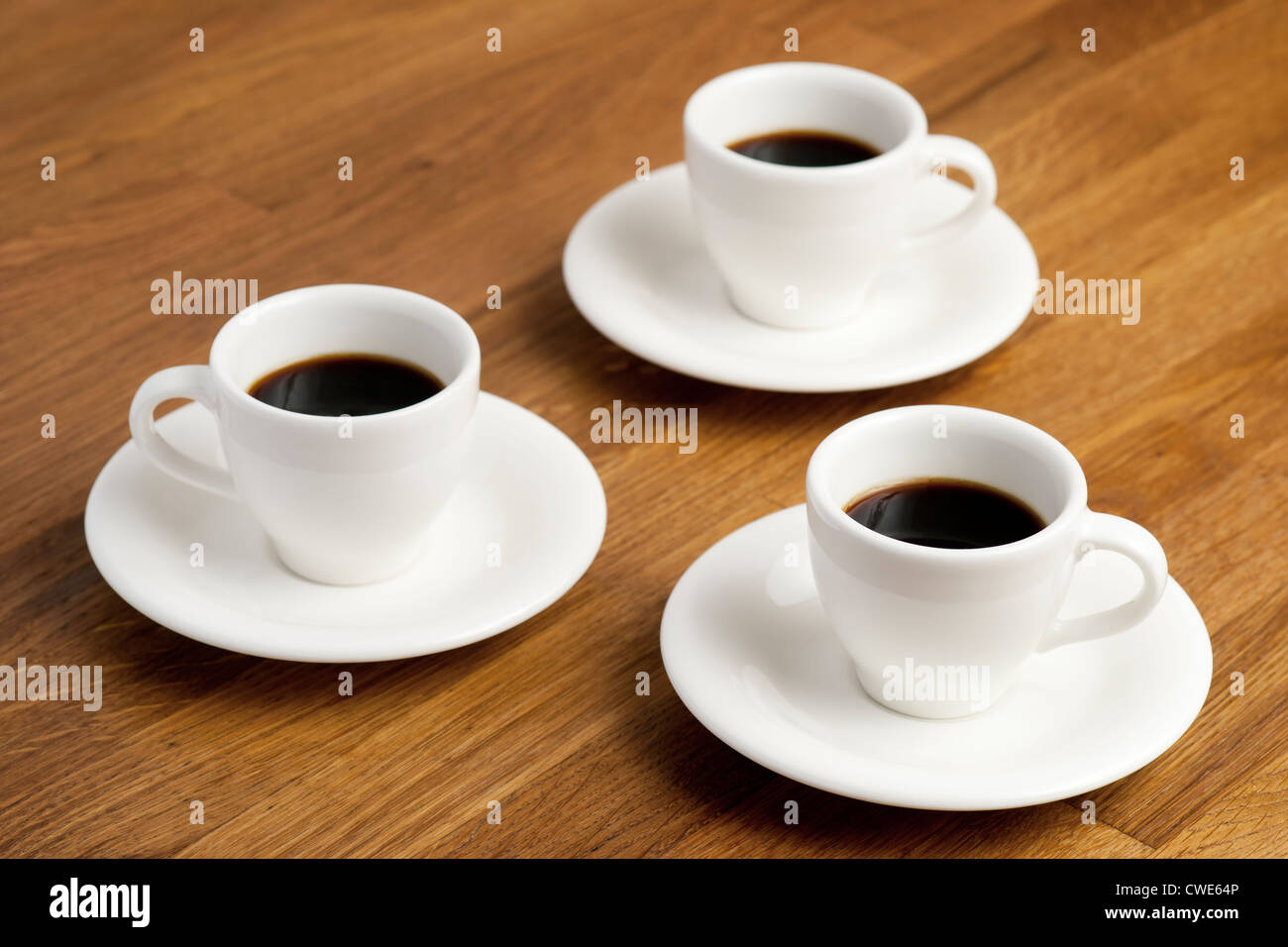 Three coffee cups on the table Stock Photo - Alamy