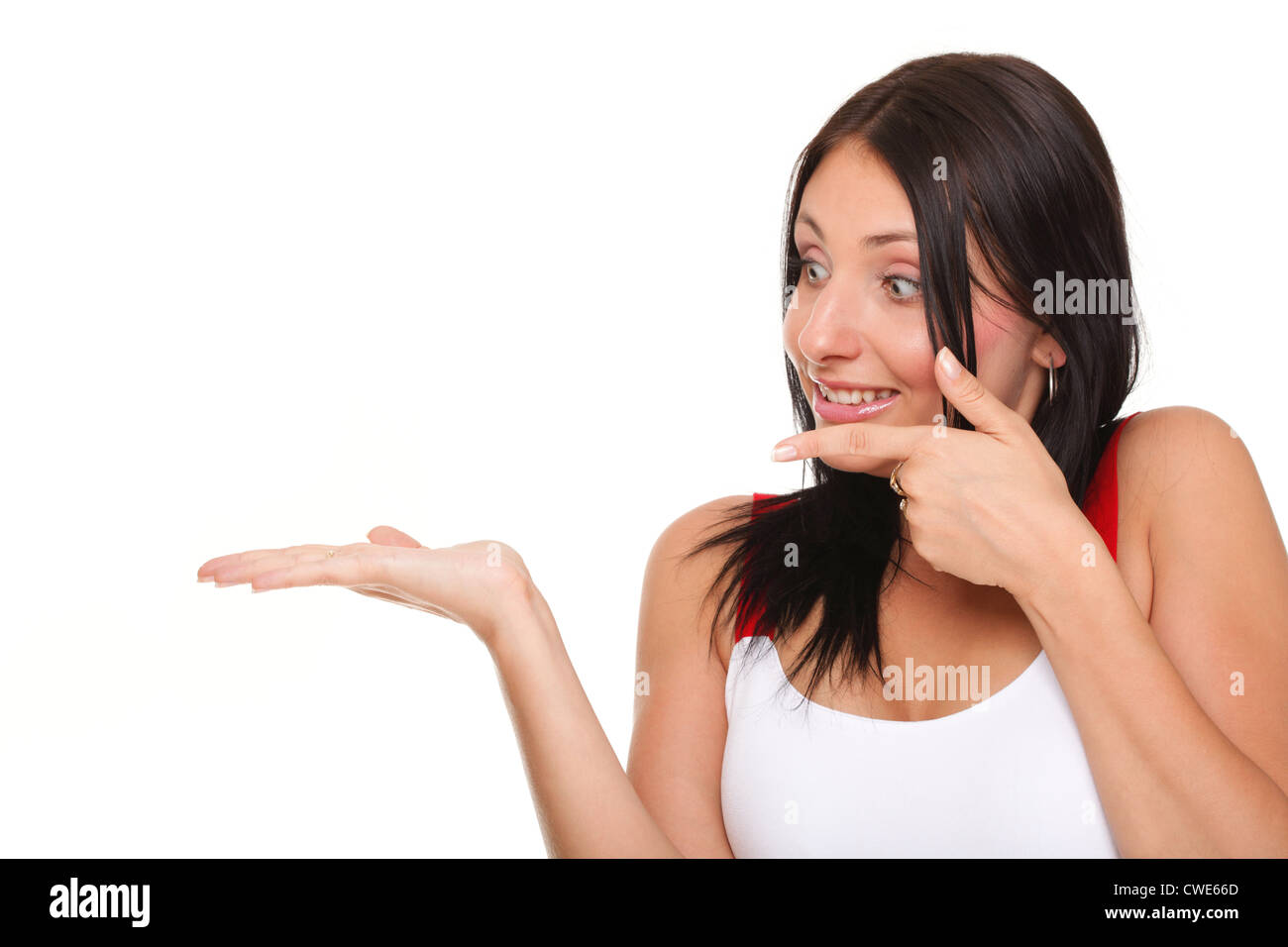 Young woman showing product with open hand palm - excited expression on ...