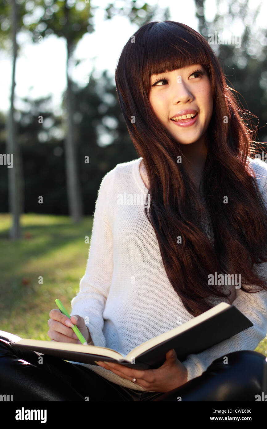 A smiling Asian student is studying Stock Photo - Alamy