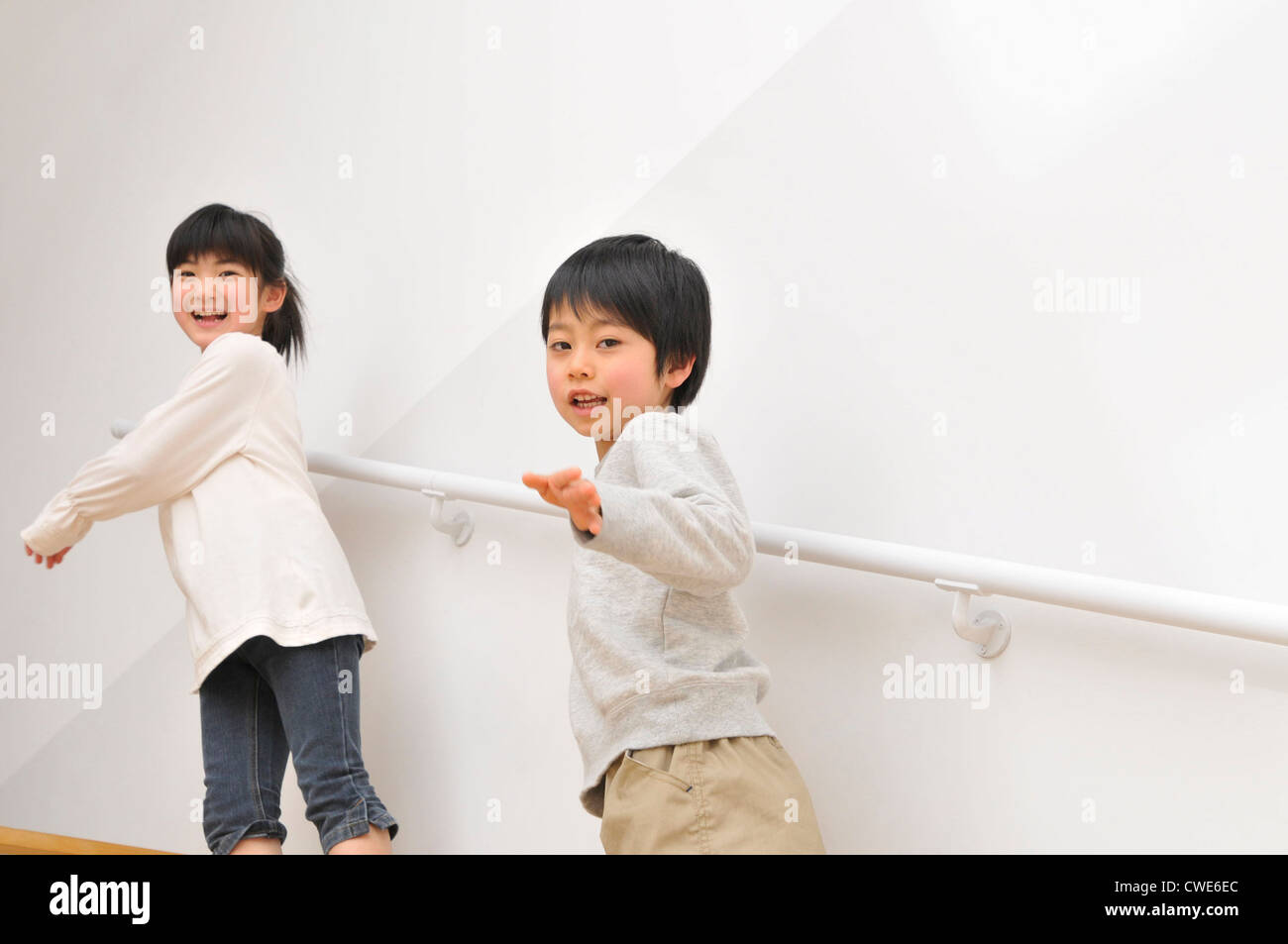 Two kids standing on stairs Stock Photo - Alamy