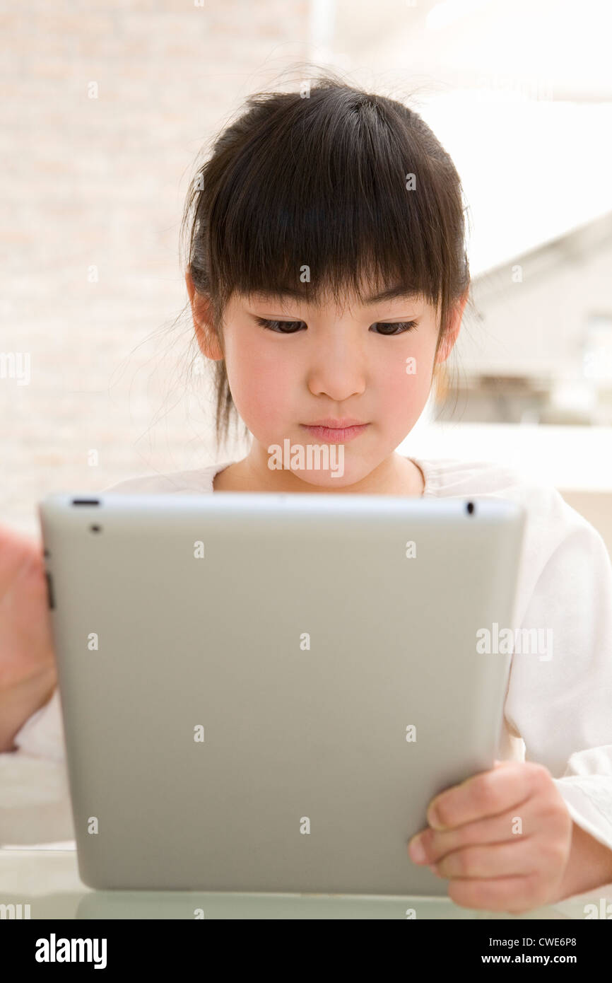 Asian kid using tablet hi-res stock photography and images - Alamy