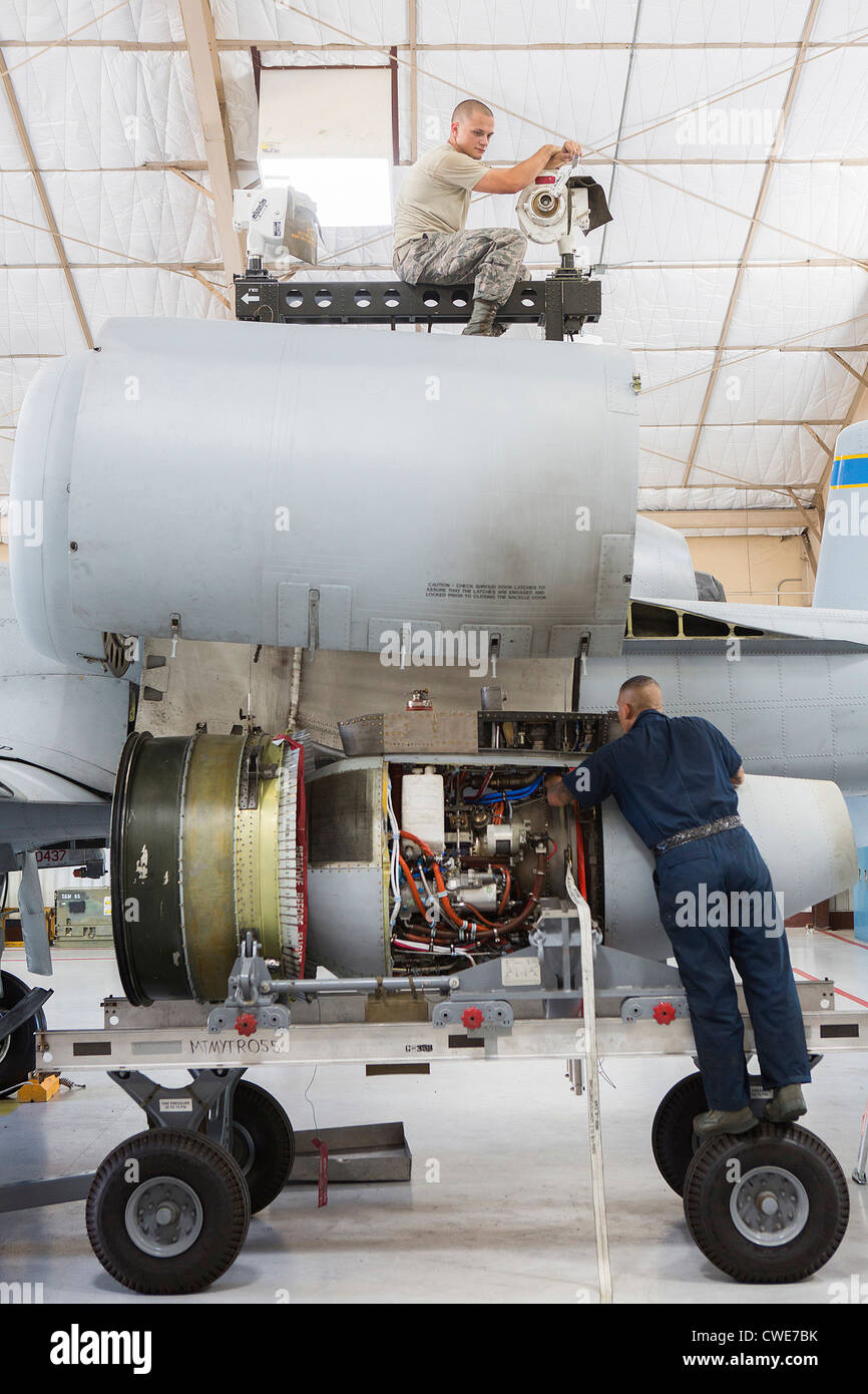 Airmen attach a jet engine to an A-10 Thunderbolt from the 354th ...