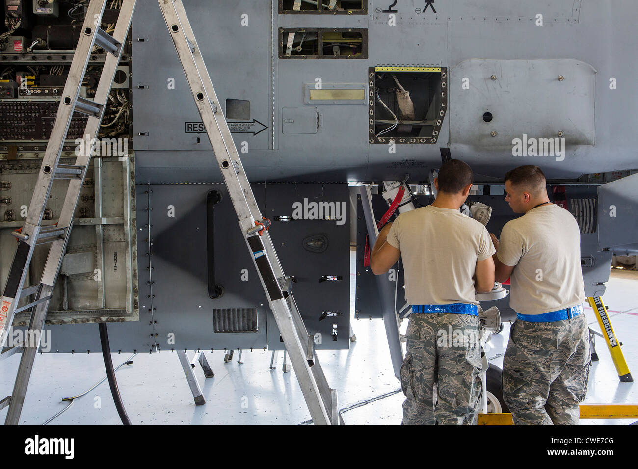 Airmen perform maintenance work on an A-10 Thunderbolt from the 354th ...