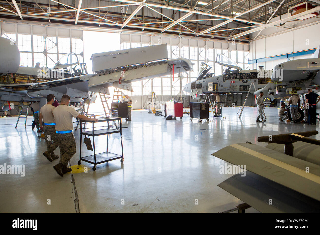 Airmen perform maintenance work on an A-10 Thunderbolt from the 354th ...