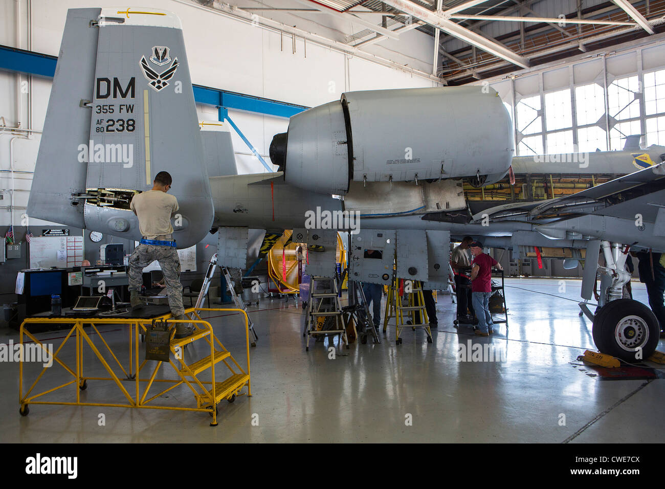 Airmen perform maintenance work on an A-10 Thunderbolt from the 354th ...