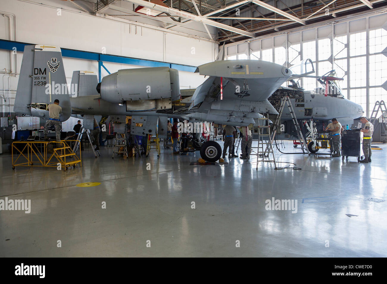 Airmen perform maintenance work on an A-10 Thunderbolt from the 354th ...