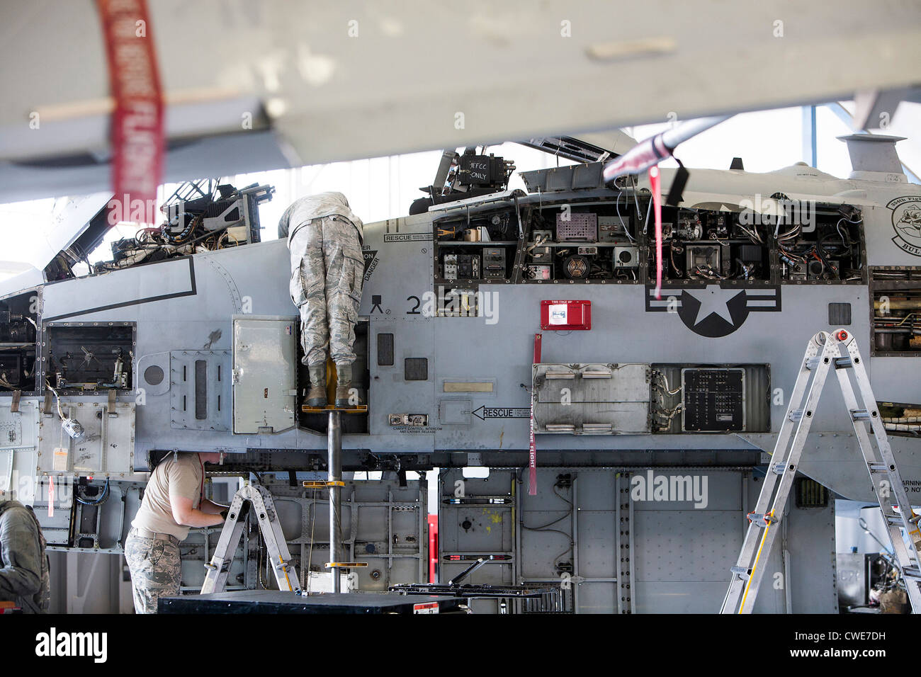 Airmen perform maintenance work on an A-10 Thunderbolt from the 354th ...