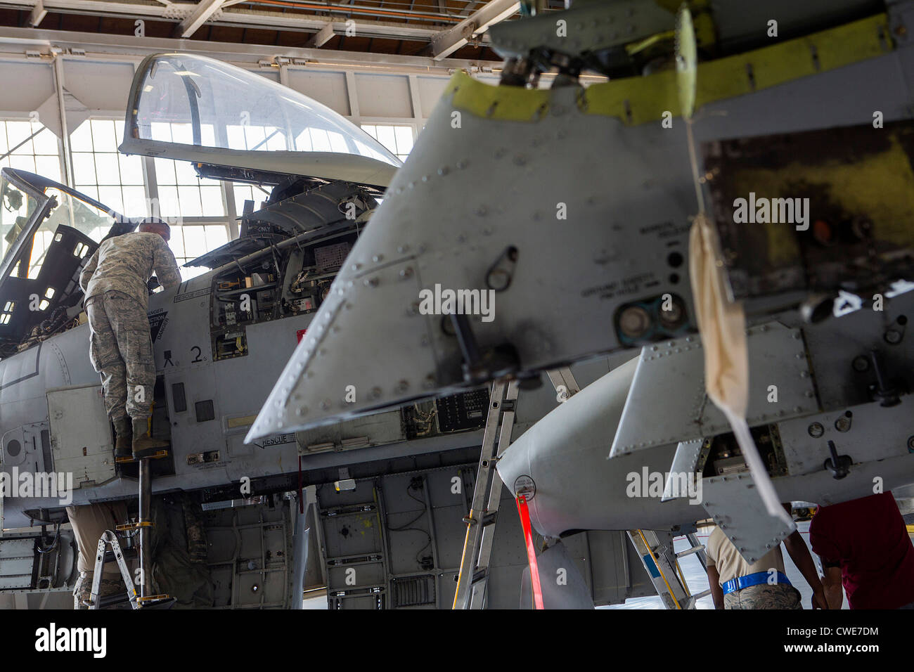Airmen perform maintenance work on an A-10 Thunderbolt from the 354th ...
