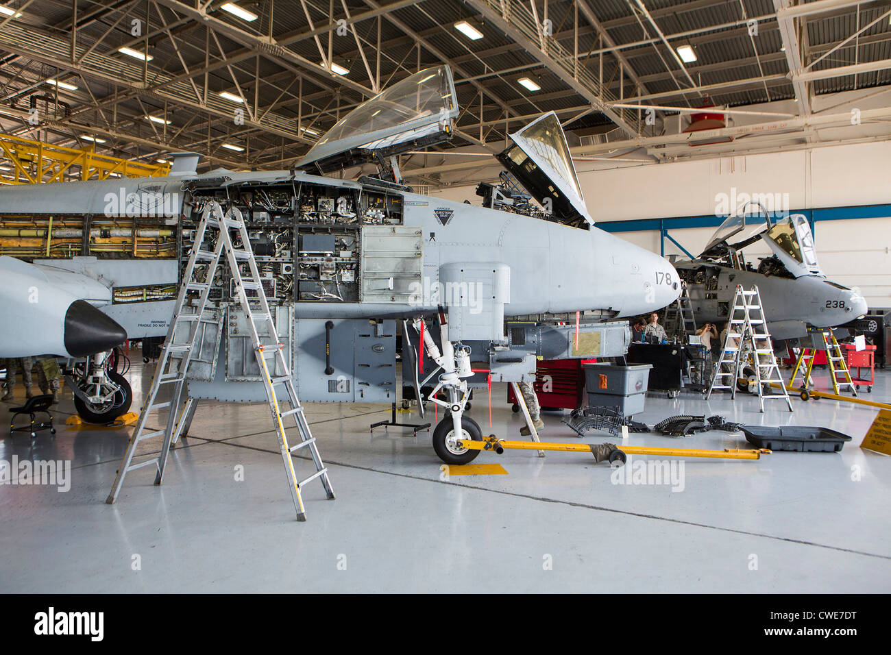 Airmen perform maintenance work on an A-10 Thunderbolt from the 354th ...