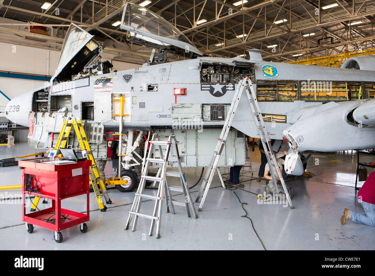 Airmen perform maintenance work on an A-10 Thunderbolt from the 354th ...