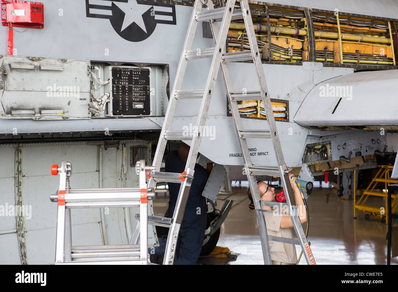 Airmen perform maintenance work on an A-10 Thunderbolt from the 354th ...