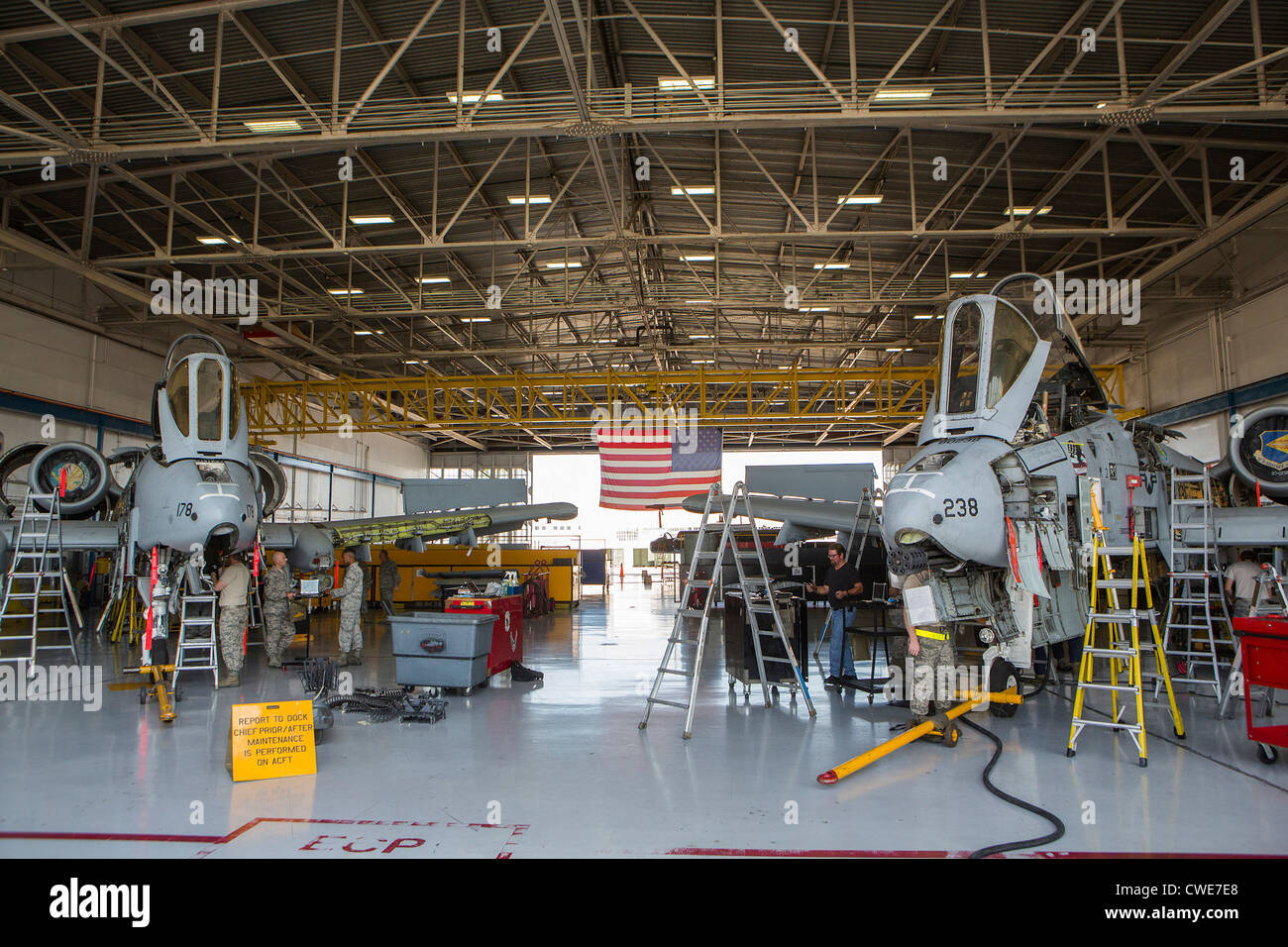 Airmen perform maintenance work on an A-10 Thunderbolt from the 354th ...
