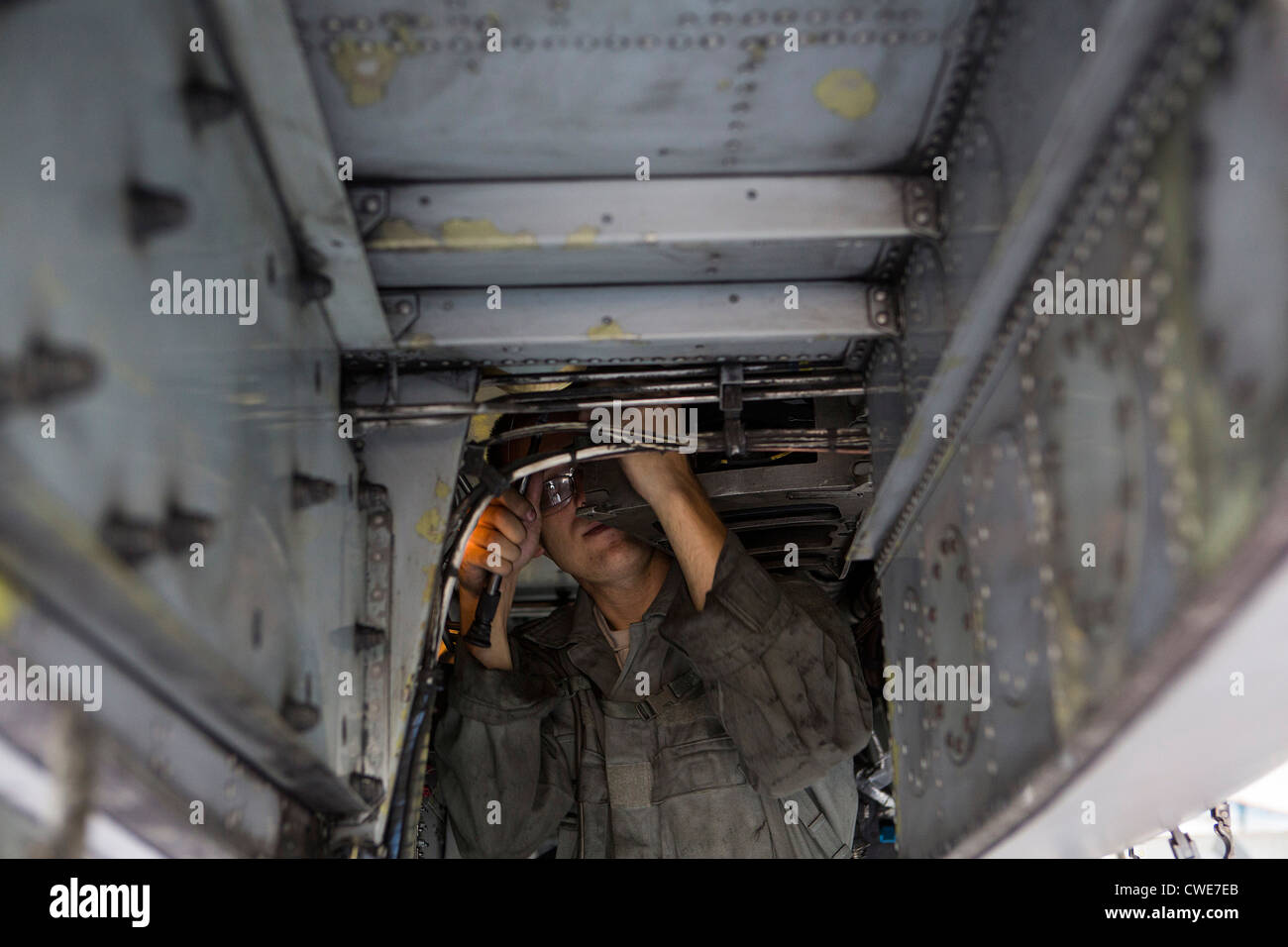 Airmen perform maintenance work on an A-10 Thunderbolt from the 354th ...
