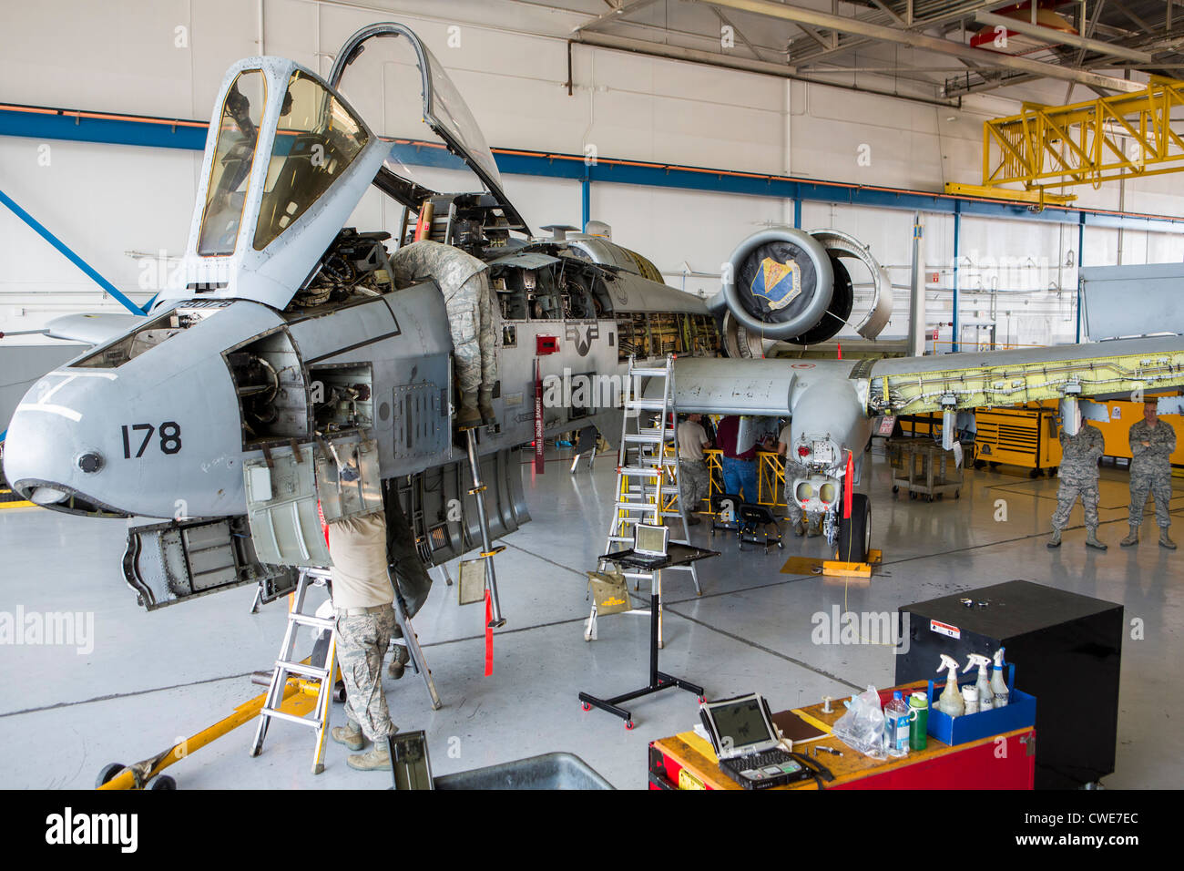 Airmen perform maintenance work on an A-10 Thunderbolt from the 354th ...