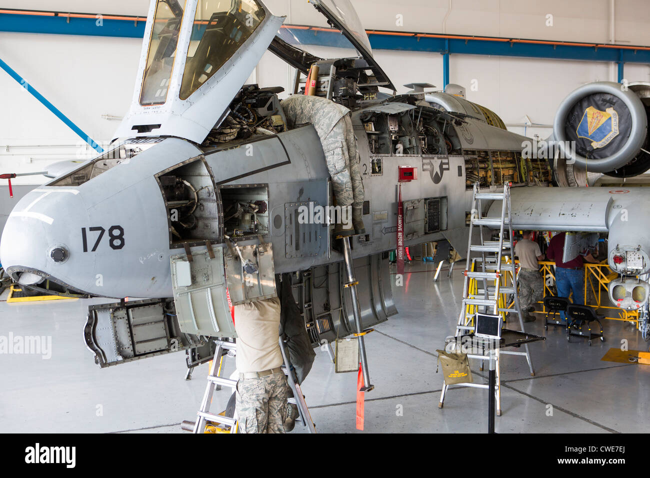 Airmen perform maintenance work on an A-10 Thunderbolt from the 354th ...
