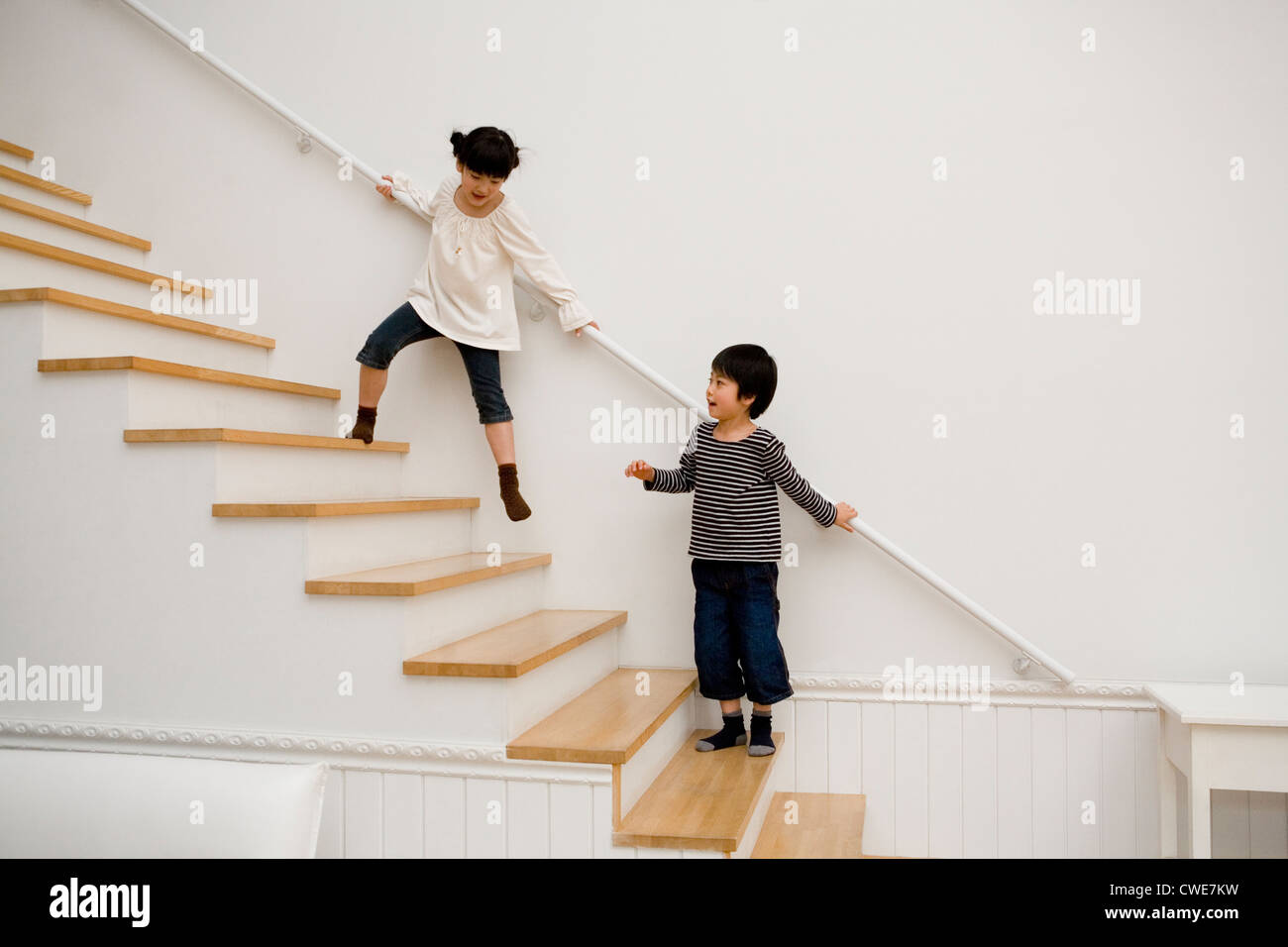 Two kids standing on stairs Stock Photo - Alamy