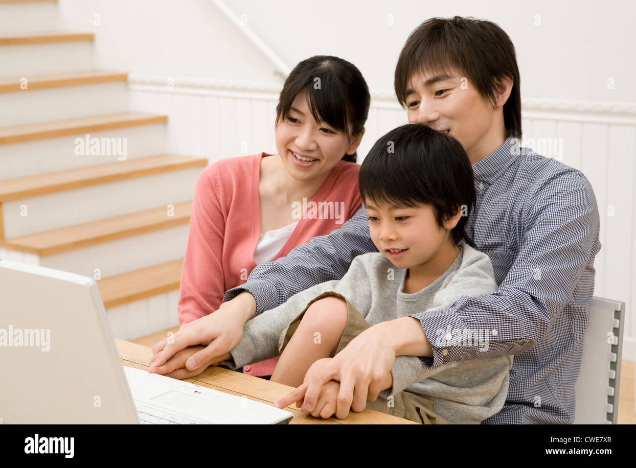 Father using laptop with son Stock Photo - Alamy