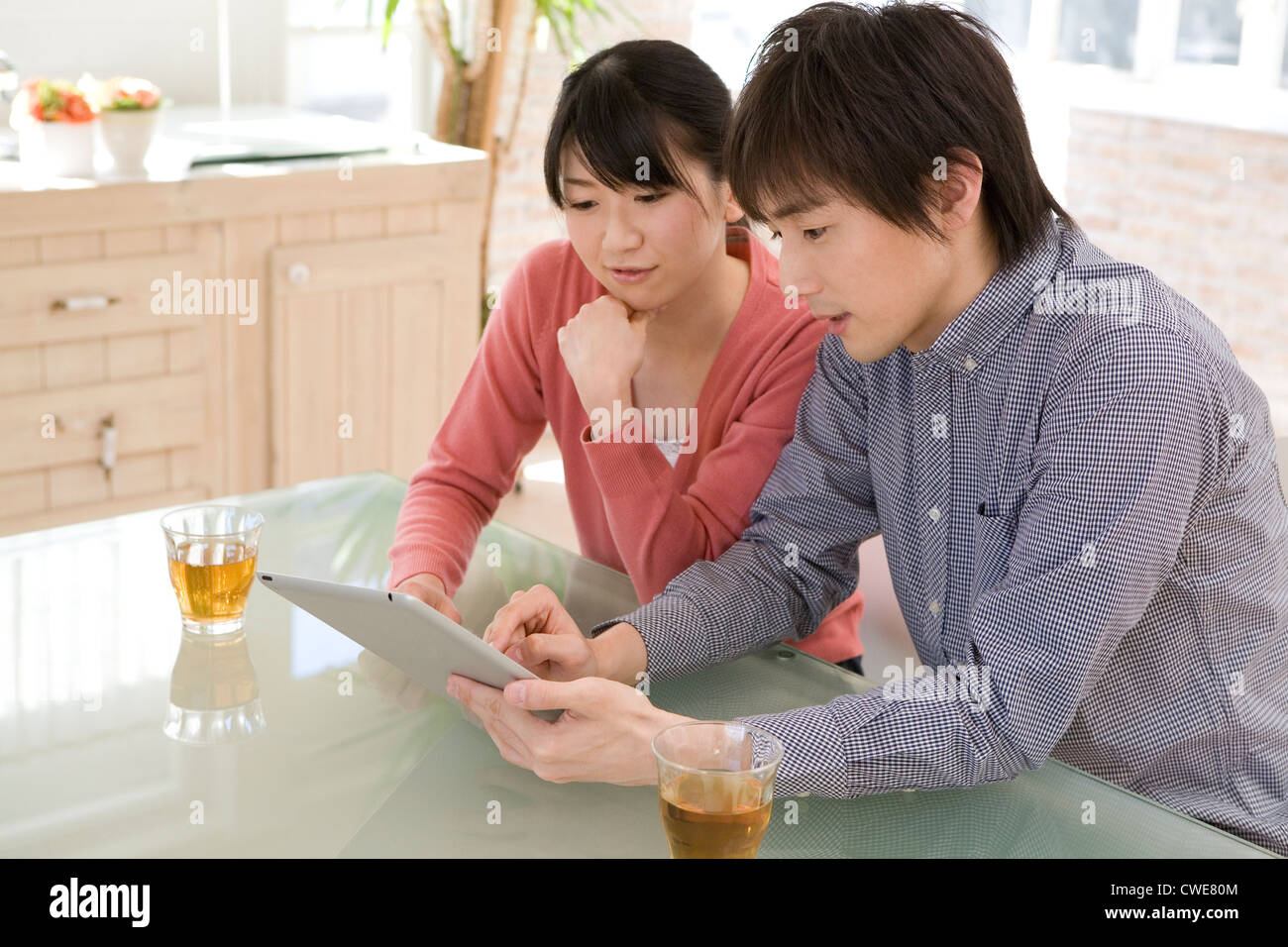 Young couple using tablet computer Stock Photo - Alamy
