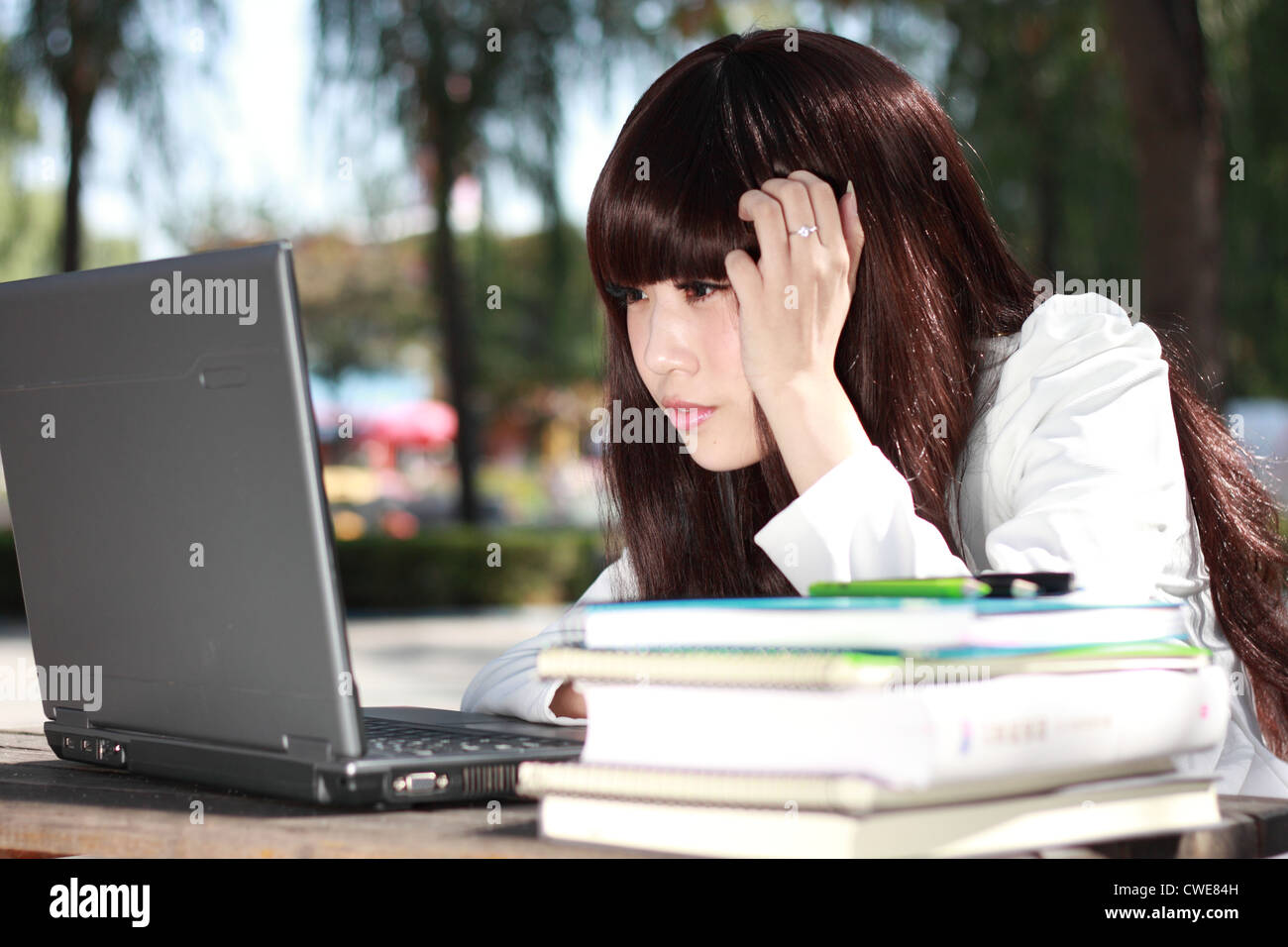 A smiling Asian student is studying Stock Photo - Alamy