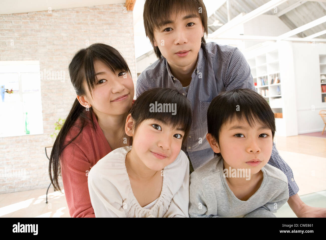 Family looking at camera and smiling Stock Photo - Alamy