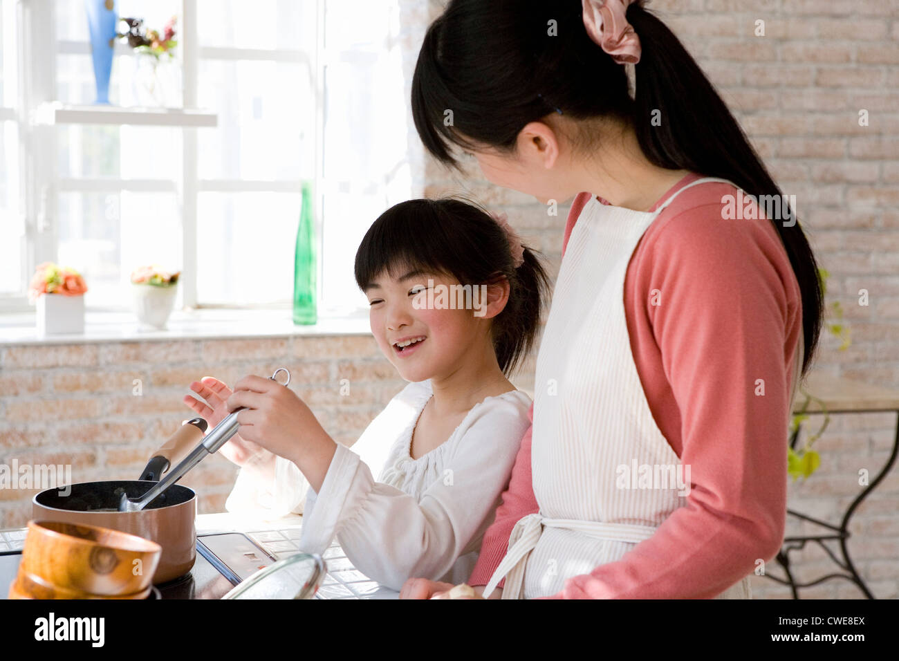 Mother and daughter cooking together Stock Photo - Alamy